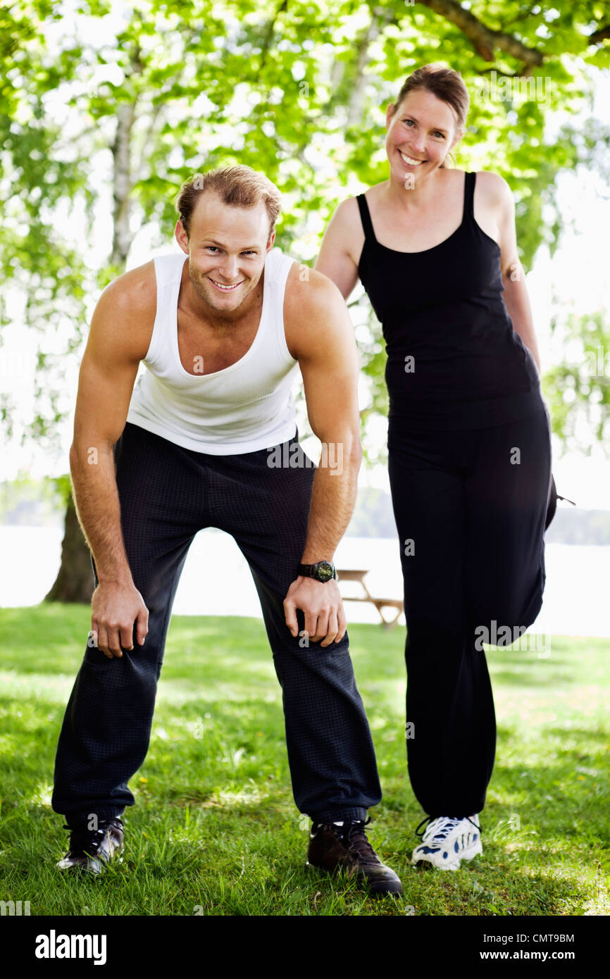 Two happy runners takes a break Stock Photo - Alamy