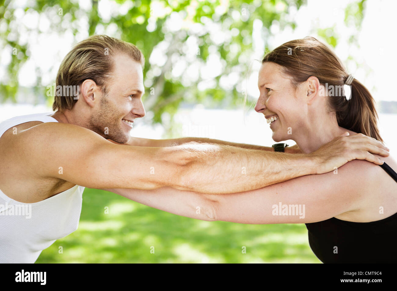 Two happy friends with hand on shoulder Stock Photo - Alamy