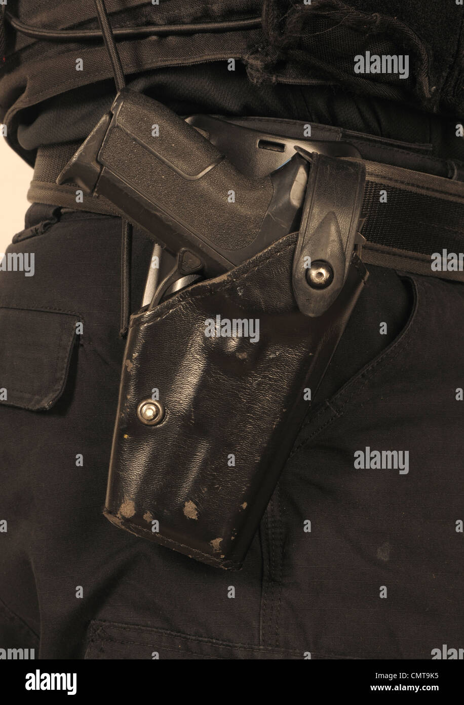 Detail of Police SWAT officer's utility belt with holstered Sig Sauer ...