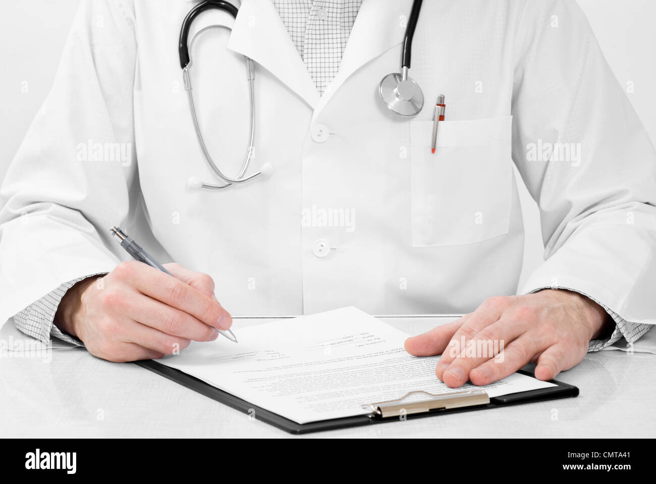 Doctor with stethoscope and clipboard writing something while sitting ...