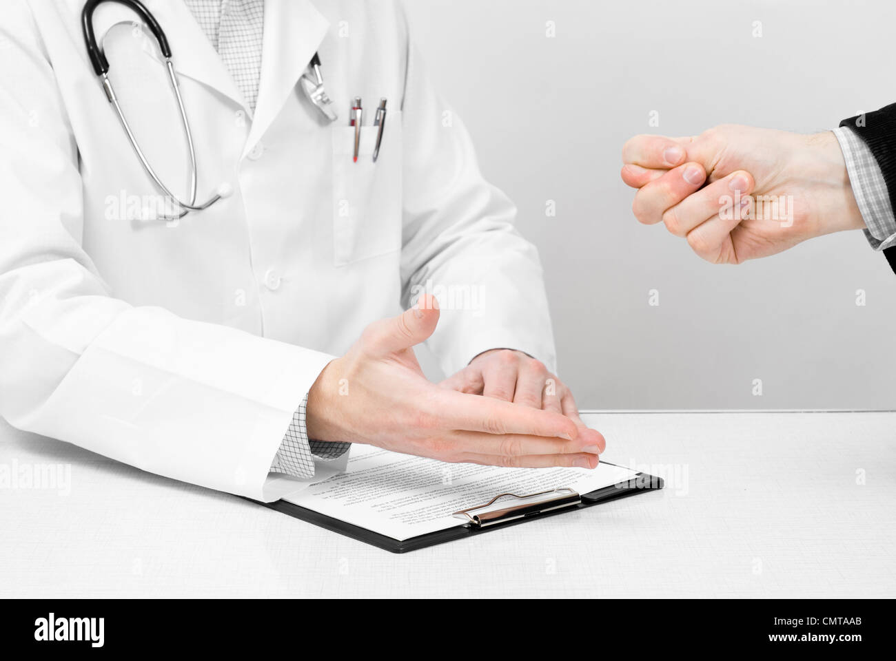 Doctor with stethoscope surprised with patients gesture saying ...