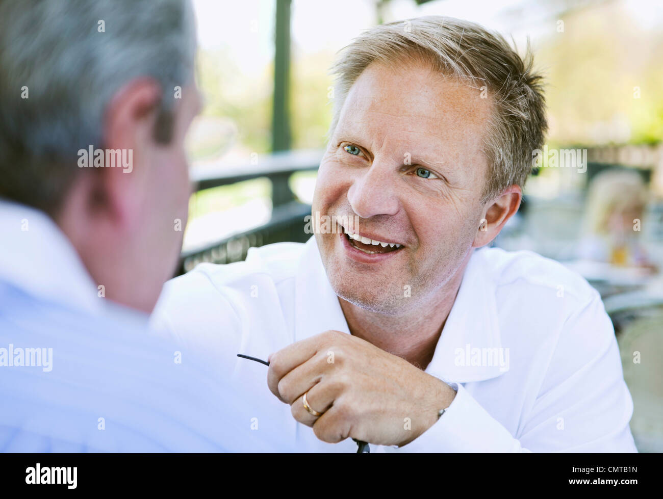 Happy men at restaurant Stock Photo - Alamy