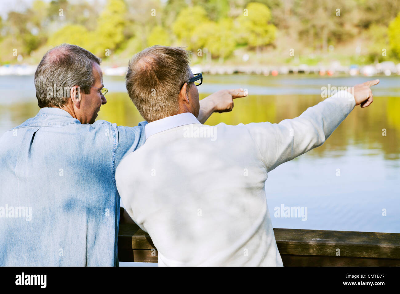 Two men pointing away Stock Photo - Alamy