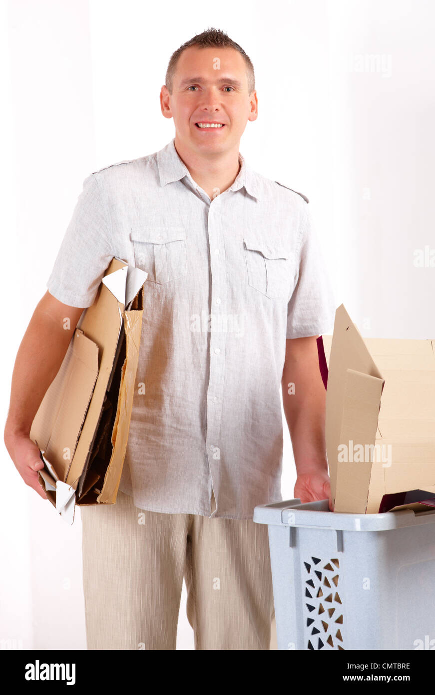 Happy man holding cardboard and bin full of paper Stock Photo - Alamy