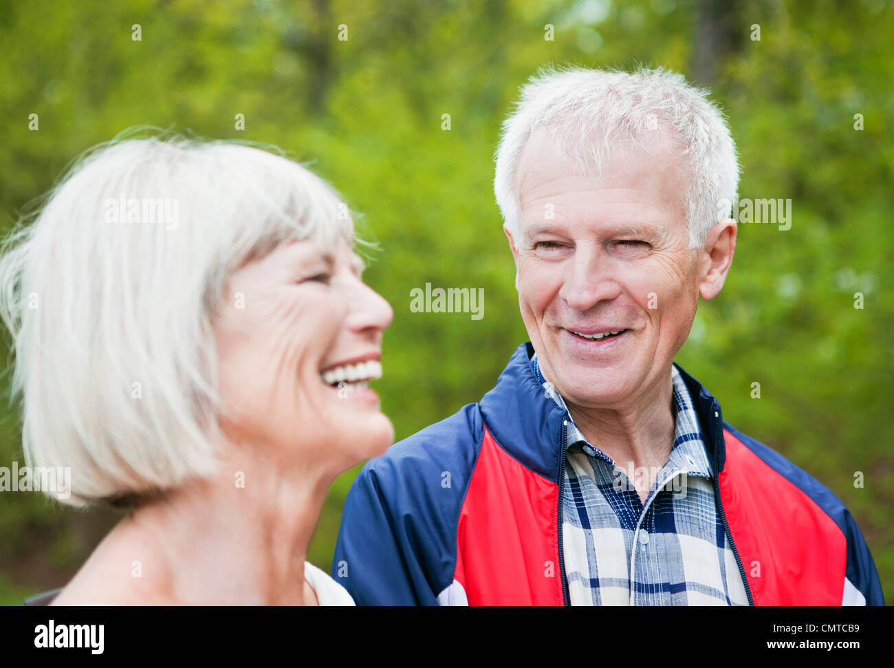 Two smiling senior citizen laughing Stock Photo - Alamy