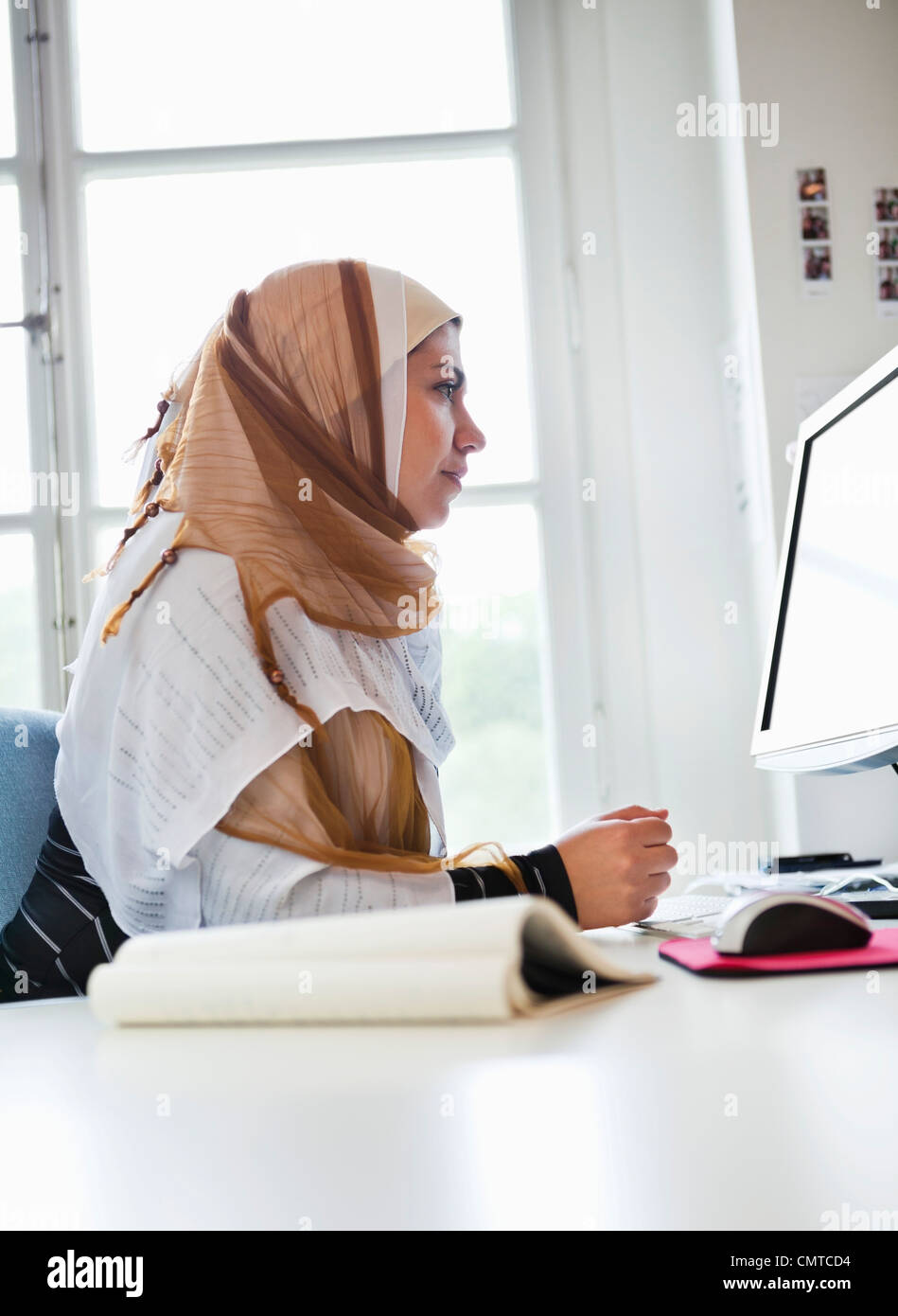 Woman working in front of computer Stock Photo - Alamy
