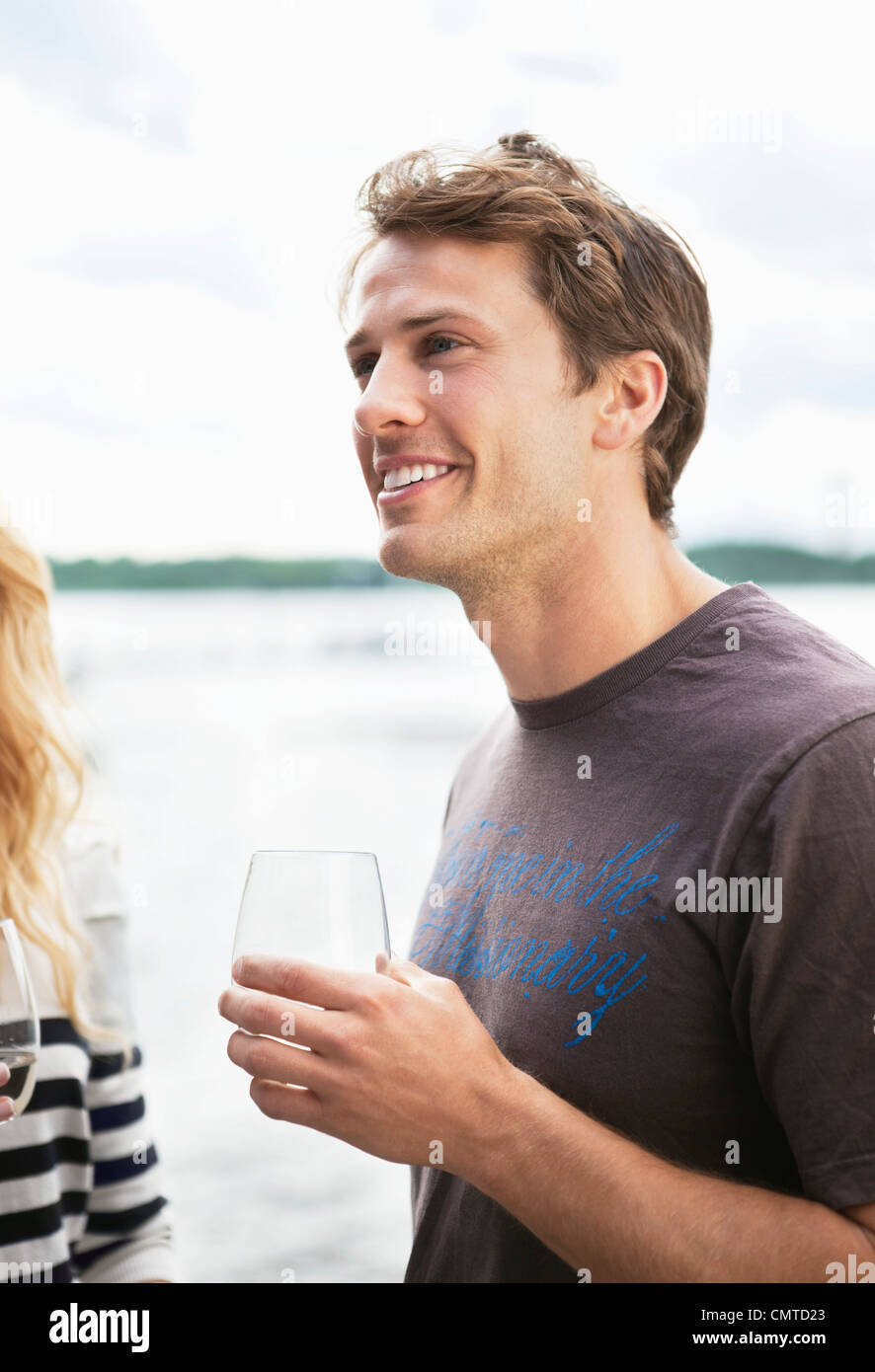Smiling young men at party Stock Photo - Alamy