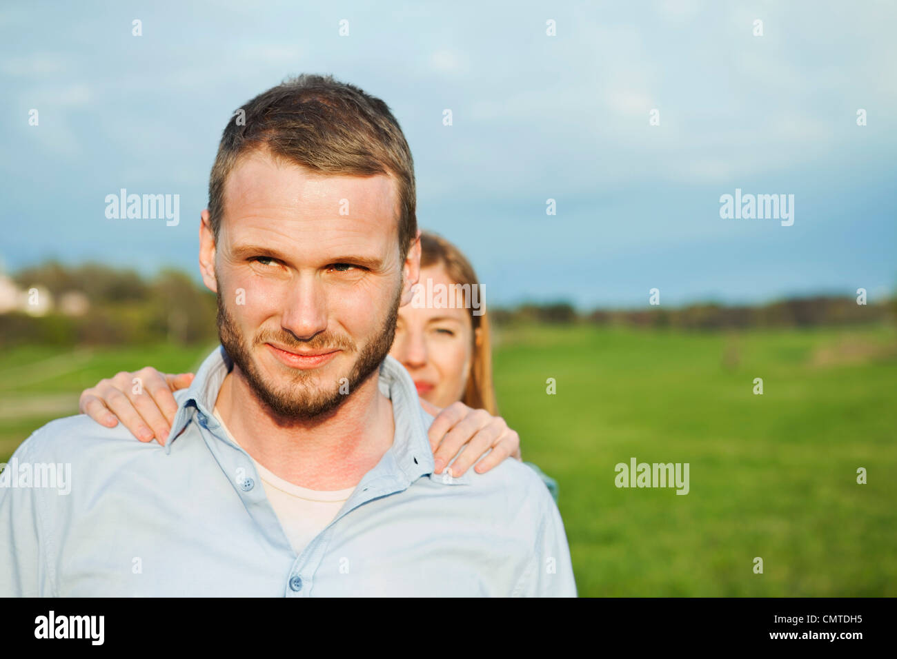 Man with hands on his shoulders Stock Photo - Alamy