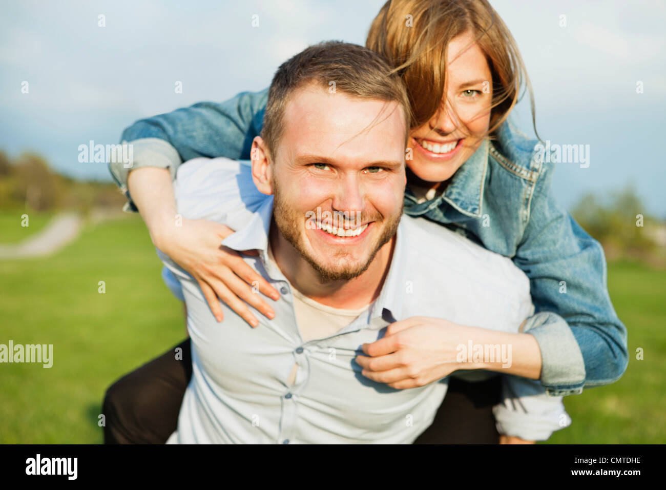 Man with woman on his back Stock Photo - Alamy