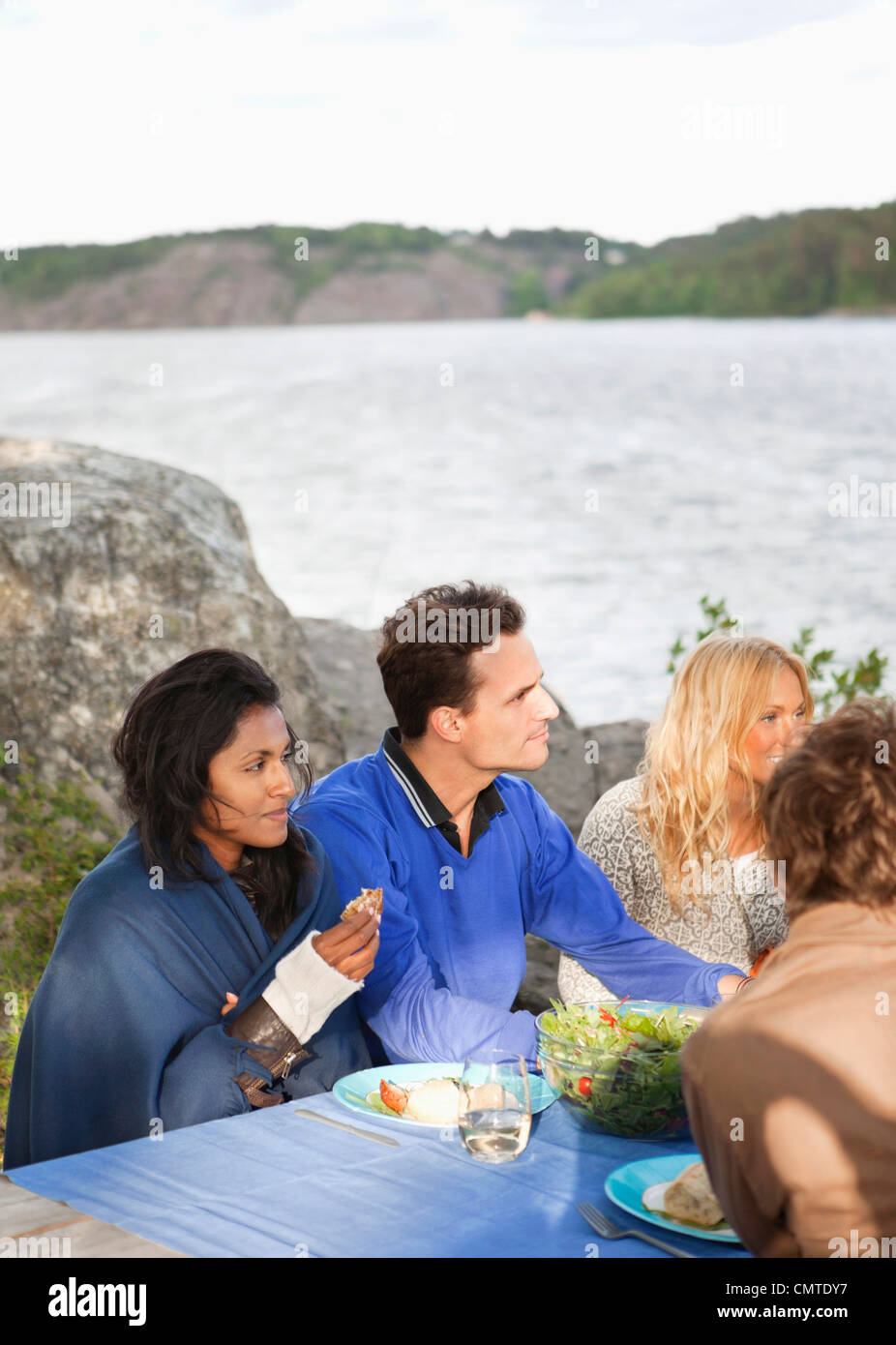 Four friends at dinner Stock Photo - Alamy