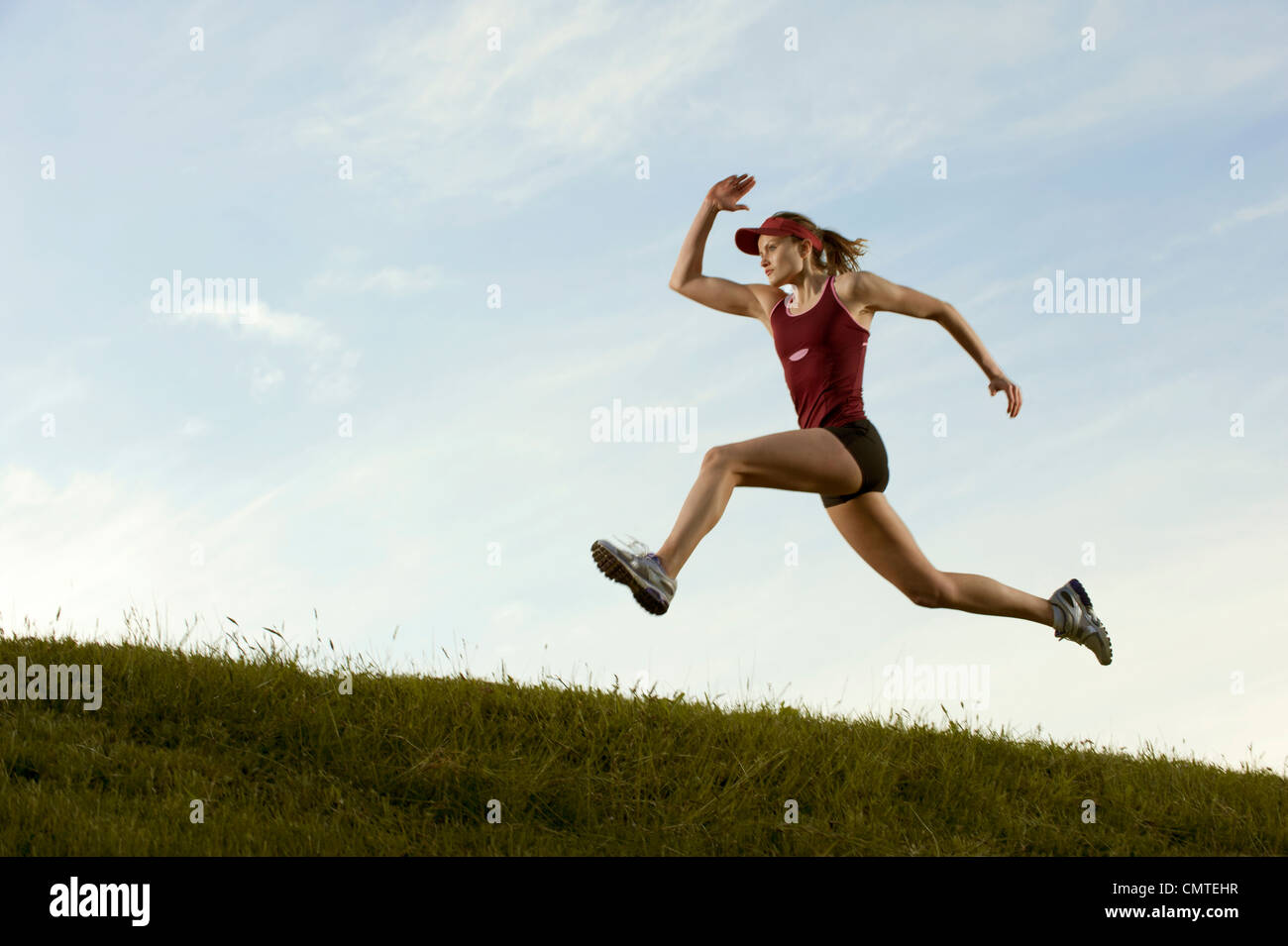 Caucasian runner running in field Stock Photo - Alamy