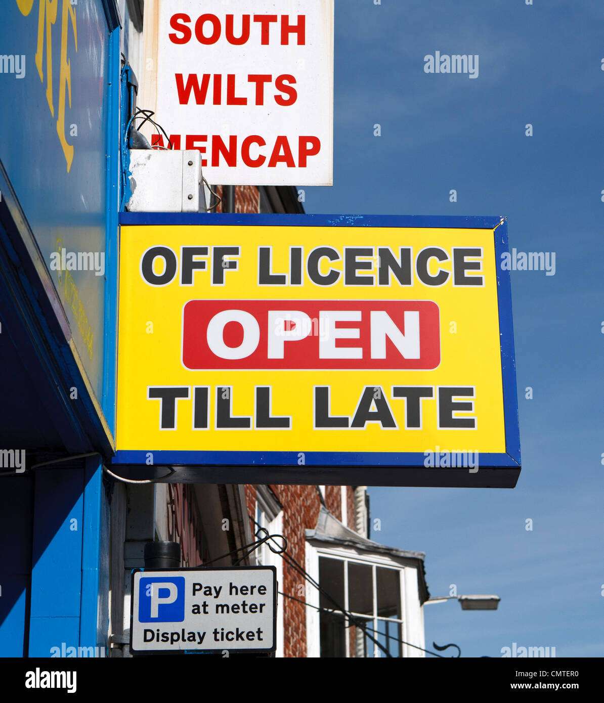 Bright yellow and red off license sign above shop Stock Photo - Alamy
