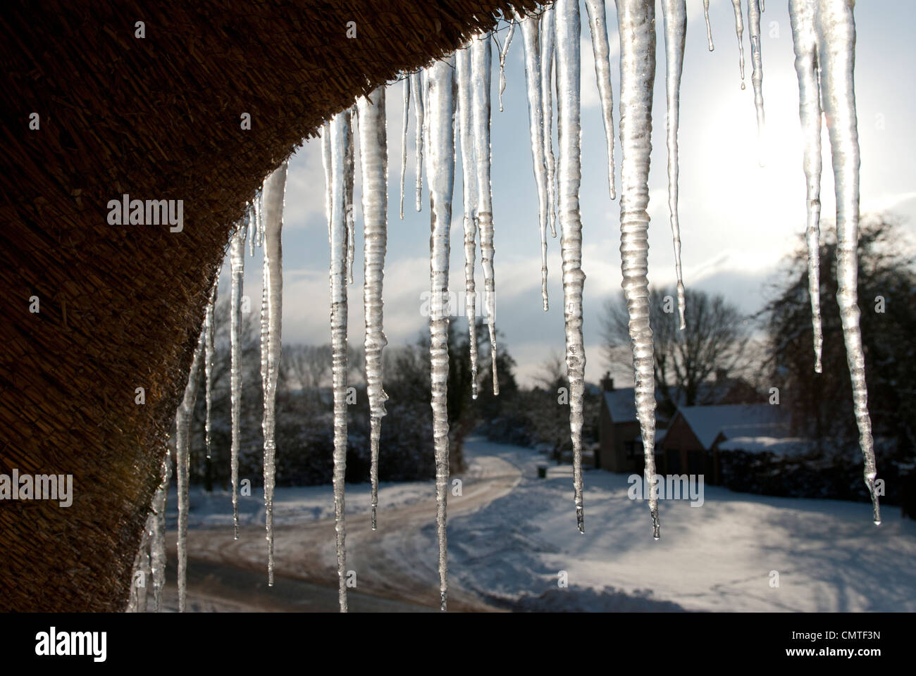 Icicles hanging from a thatched roof Stock Photo - Alamy