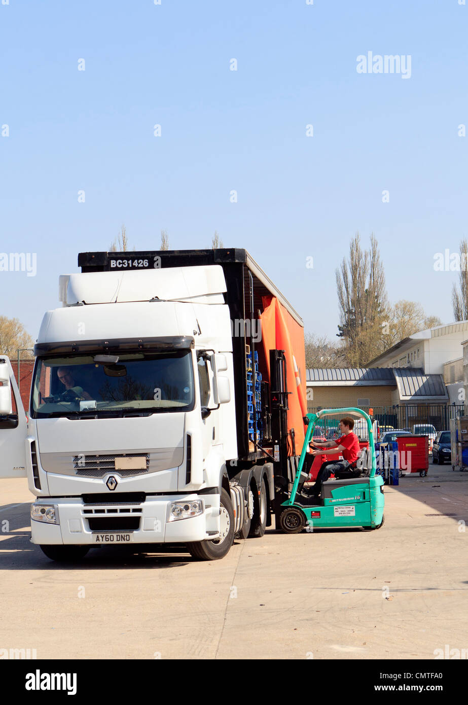 Mitsubishi forklift truck loading articulated lorry Stock Photo - Alamy