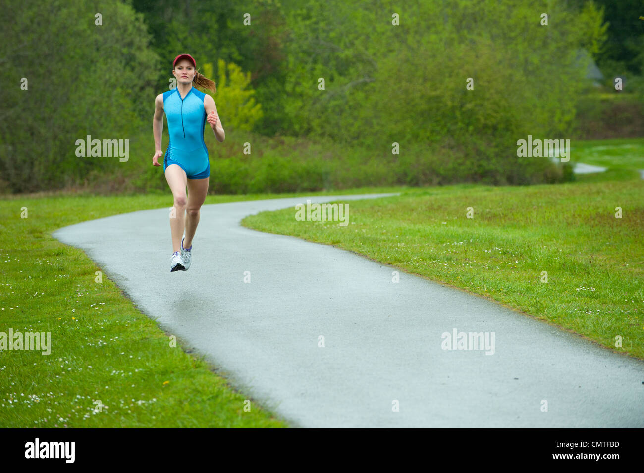 Mixed race runner training on remote road Stock Photo - Alamy