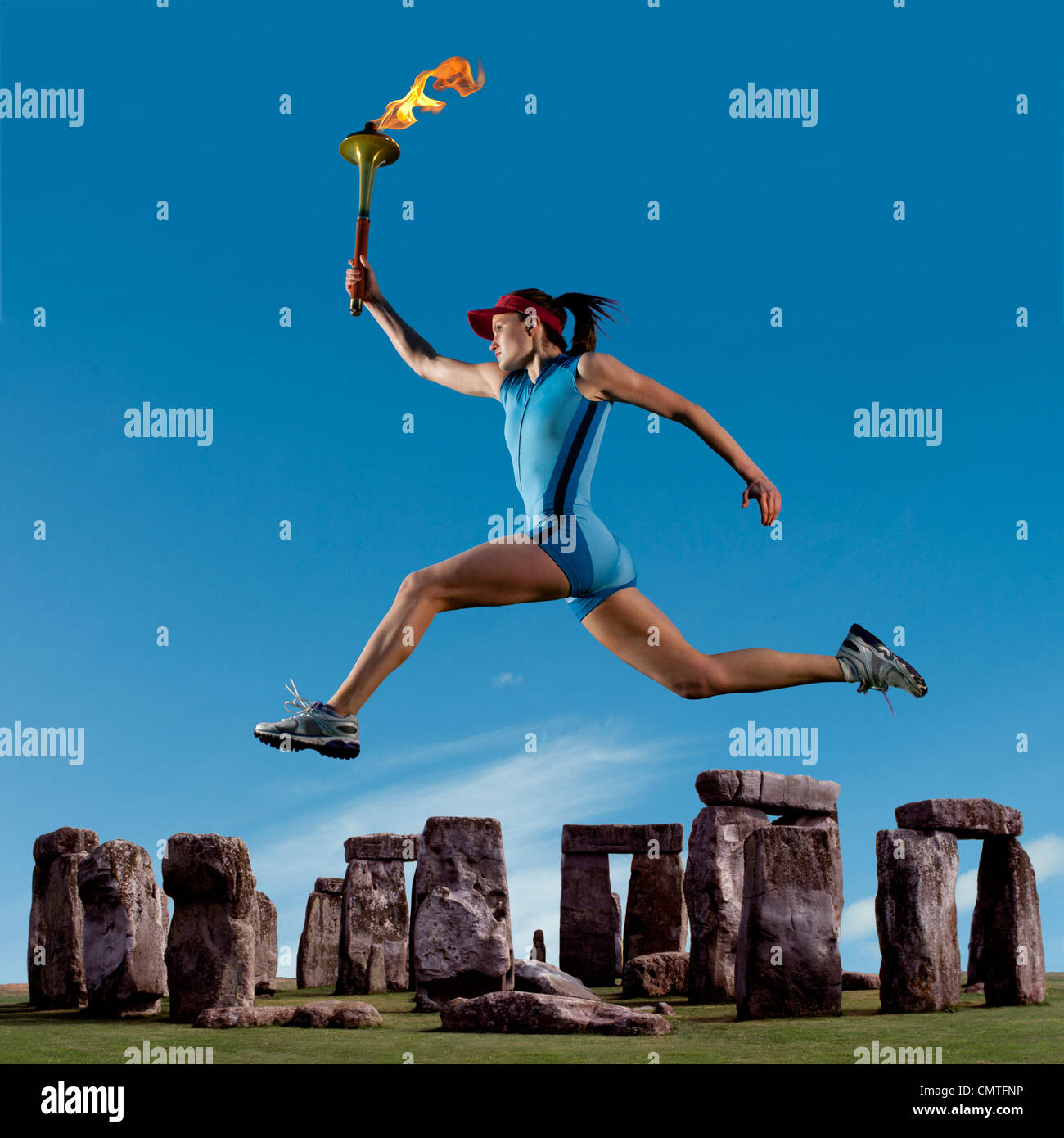 Athlete running with Olympic torch near Stonehenge Stock Photo - Alamy