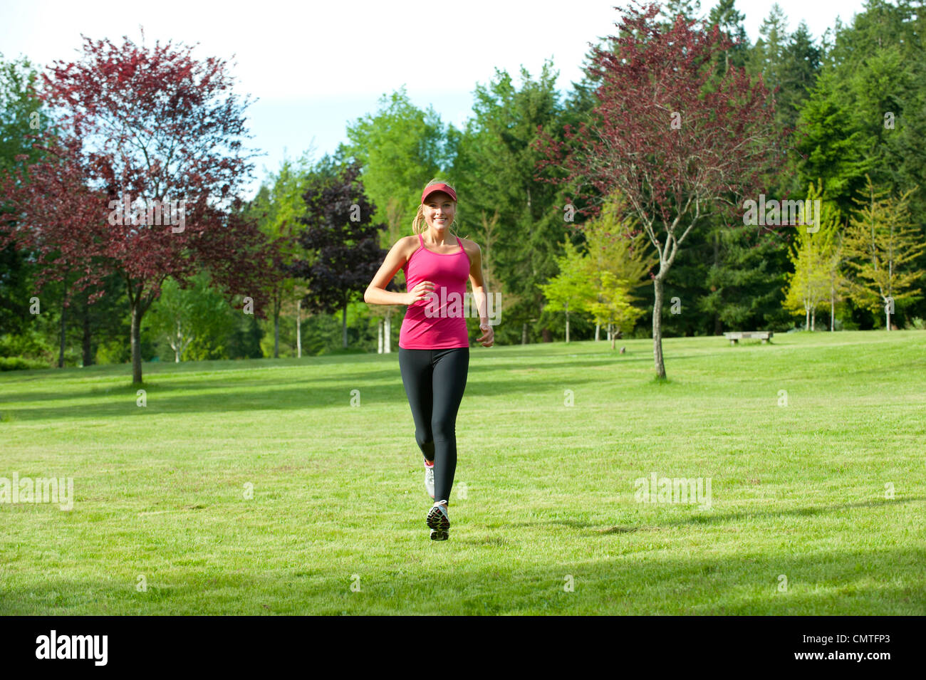 Jogger running through field Stock Photo - Alamy