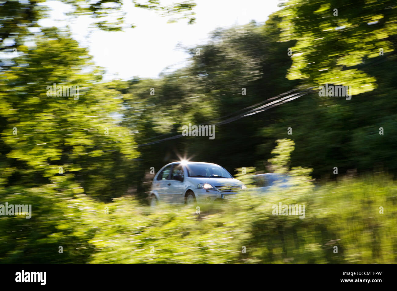 Car moving in speed at forest Stock Photo - Alamy