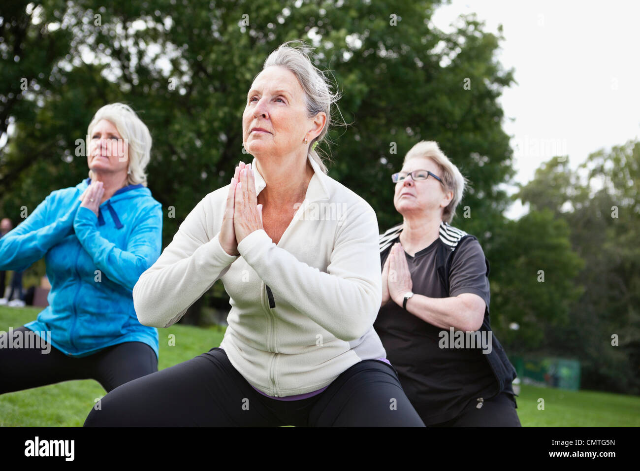 Women with hands clasped exercising Stock Photo - Alamy