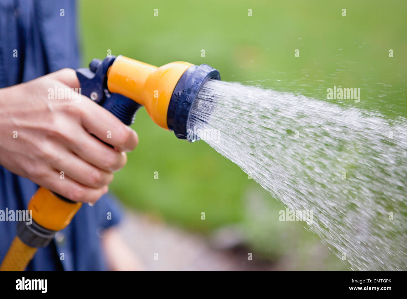 Water hose spraying water Stock Photo - Alamy