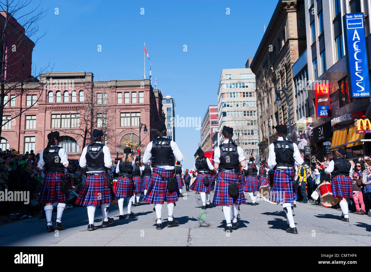 Traditional band marching on Ste Catherine street in Montreal during ...