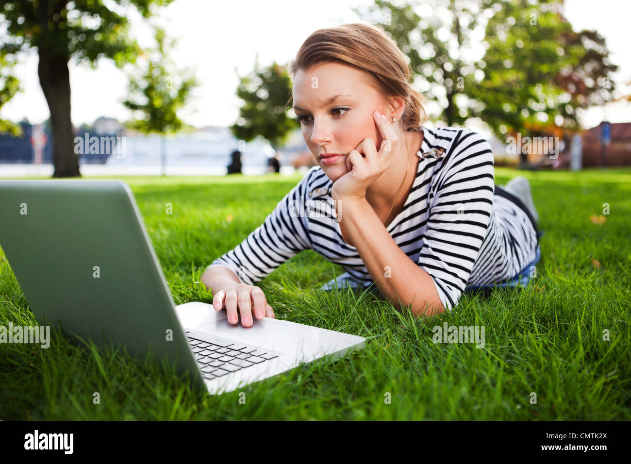 Serious woman looking at computer Stock Photo - Alamy