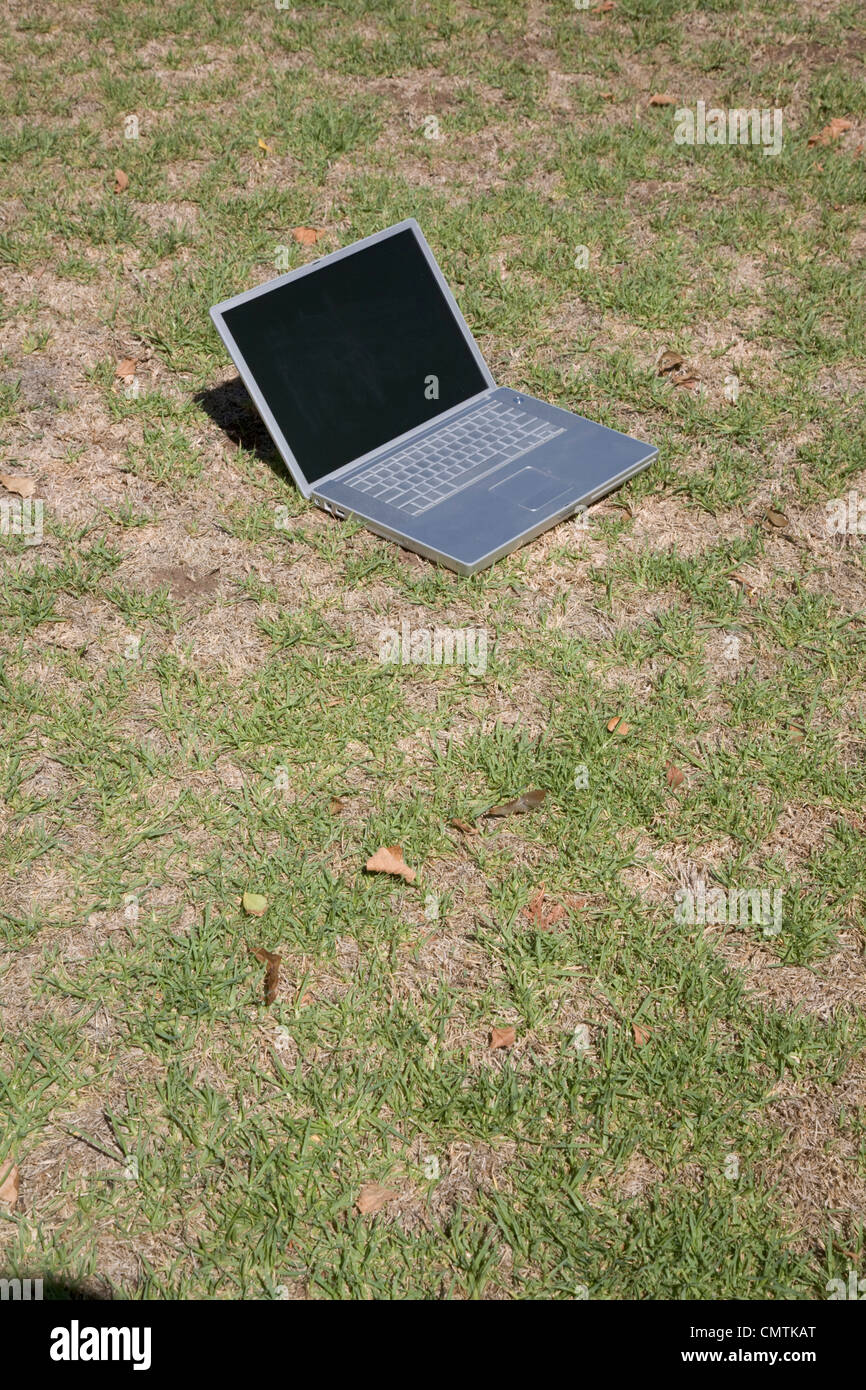 Open laptop computer on grass lawn Stock Photo - Alamy