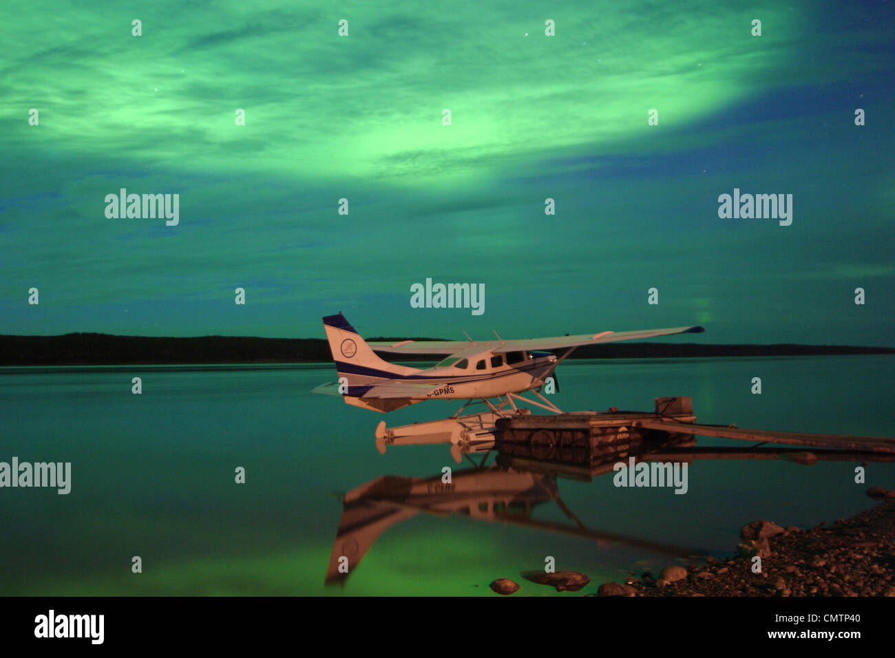 Aurora borealis or northern lights over float plane and Mackenzie River ...
