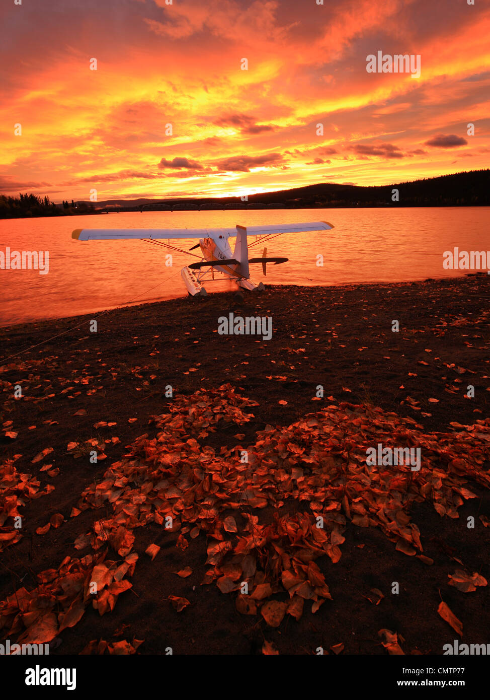 A float plane facing the sunrise over Teslin Lake, Yukon Stock Photo ...