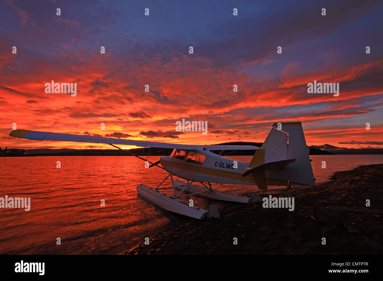 A float plane facing the sunrise over Teslin Lake, Yukon Stock Photo ...