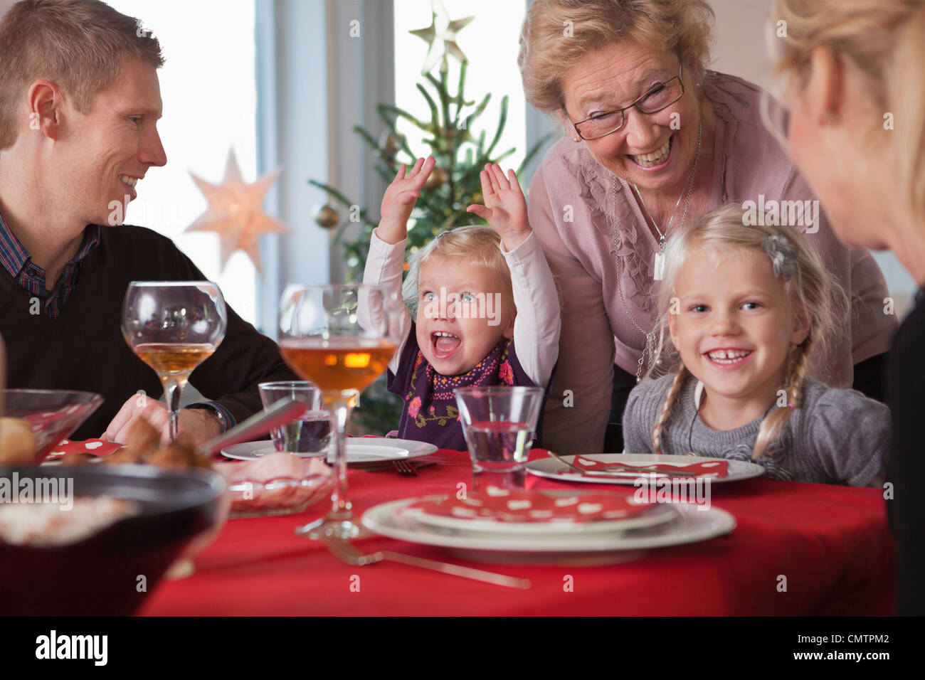 Happy family at dinner table Stock Photo - Alamy