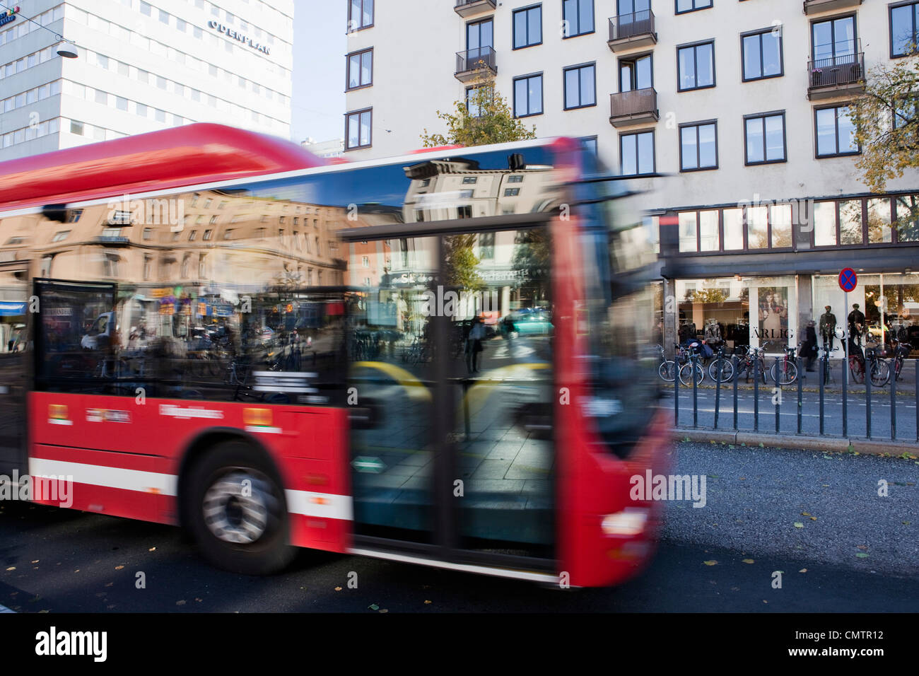 Bus driving in city Stock Photo - Alamy