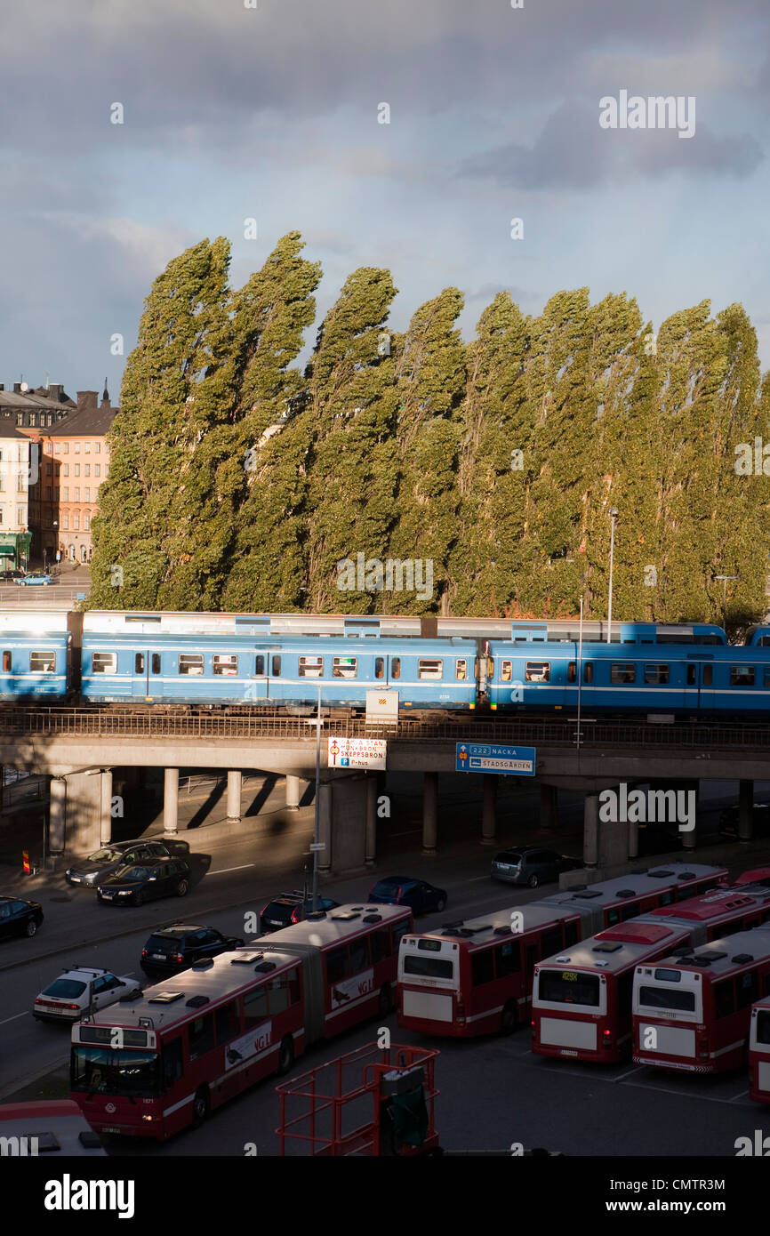Bridge with train over bus Stock Photo - Alamy