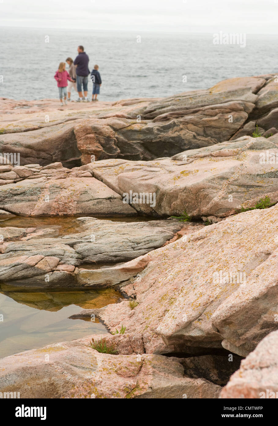 Rocky shoreline with a family standing in the distance, Highlands ...