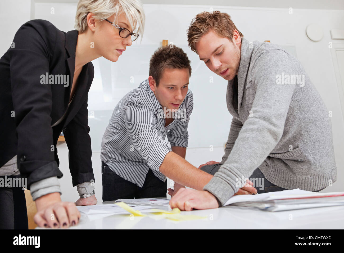 Three people working together Stock Photo - Alamy