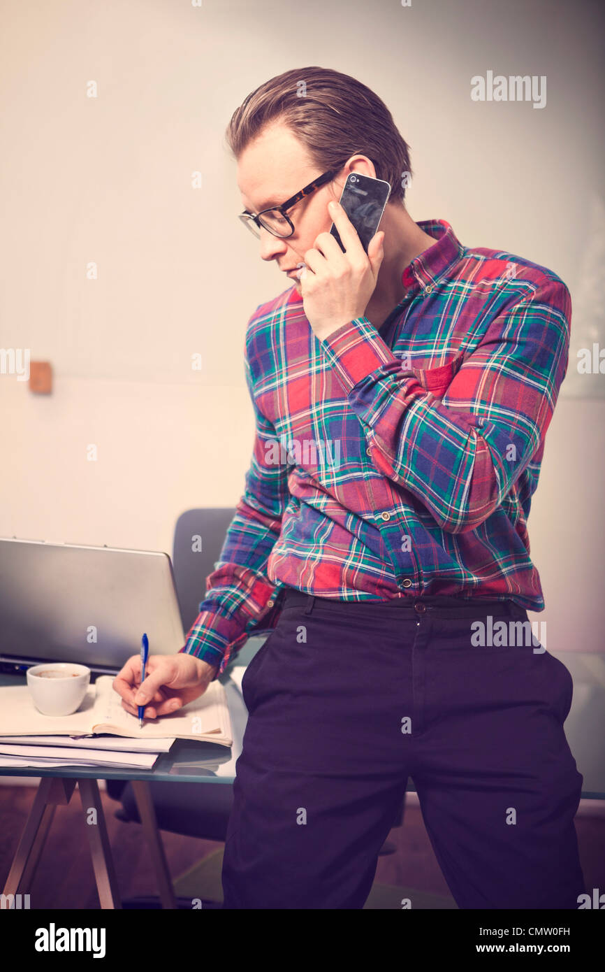 businessman noting something while on call Stock Photo - Alamy