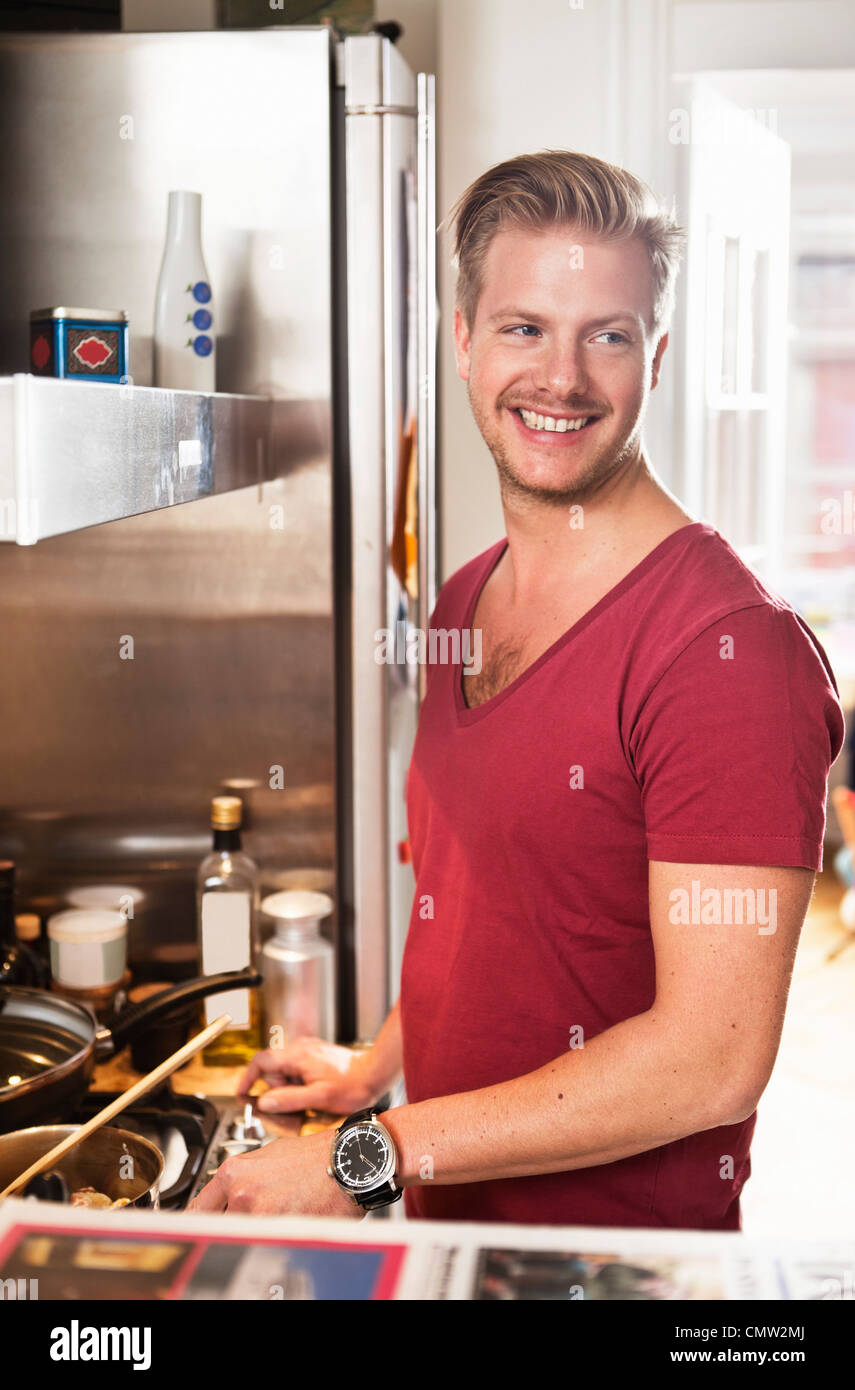 Guy cooking in kitchen Stock Photo - Alamy