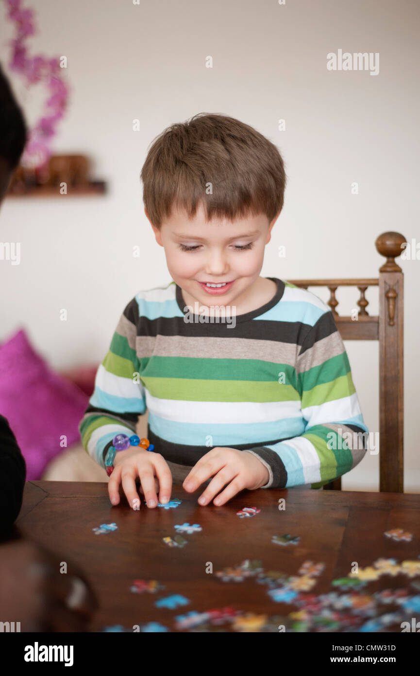 Boy Completing Jigsaw Puzzle Stock Photo Alamy boy-completing-jigsaw-puzzle-stock-photo-alamy