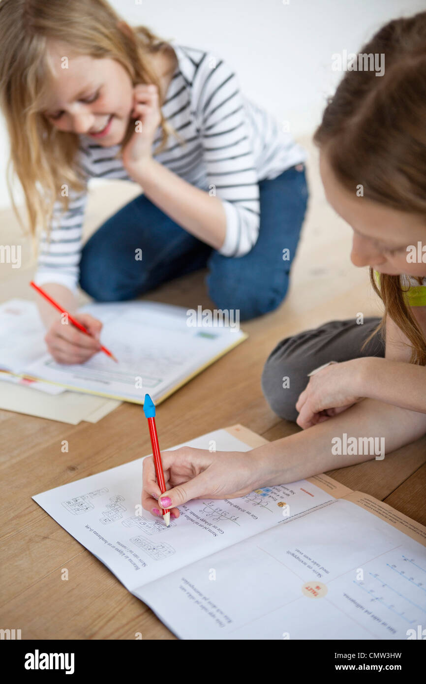 Sisters doing their homework Stock Photo - Alamy