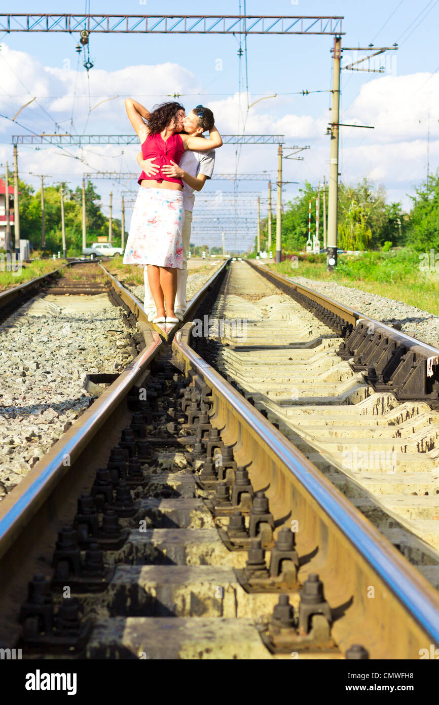 Beautiful happy love couple on rails outdoor Stock Photo - Alamy