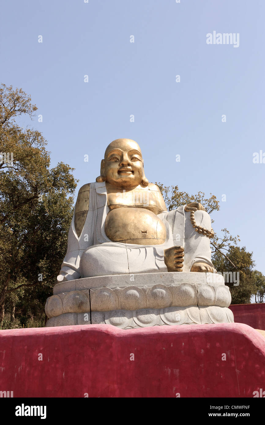 Bronze smiley buddha statue exhibited in an public garden Stock Photo ...
