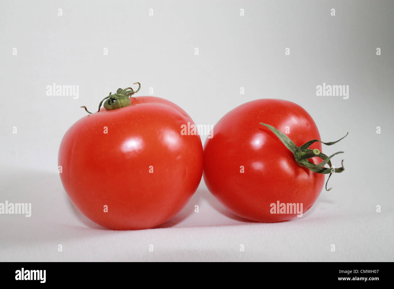 Two beautiful red tomatoes Stock Photo - Alamy