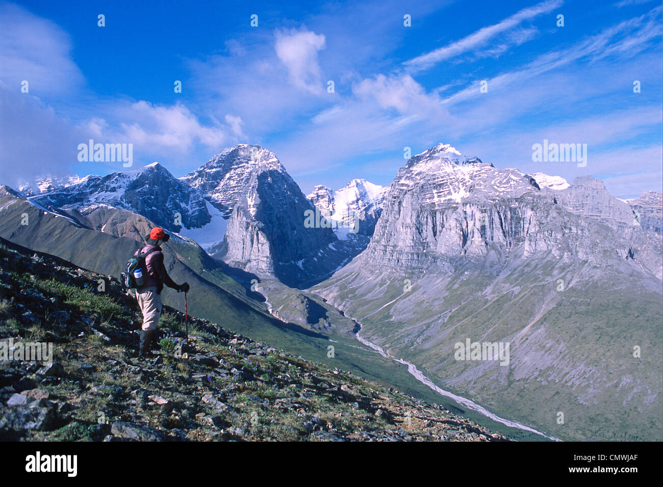 Hiker on looking out to snow capped Mt. MacDonald, MacKenzie Mountains ...
