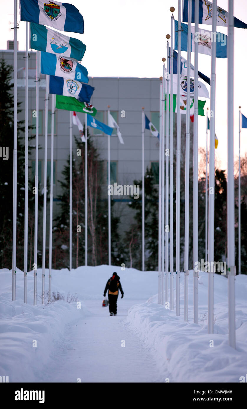 Person Walking past the Flags of Northwest Territories and its ...