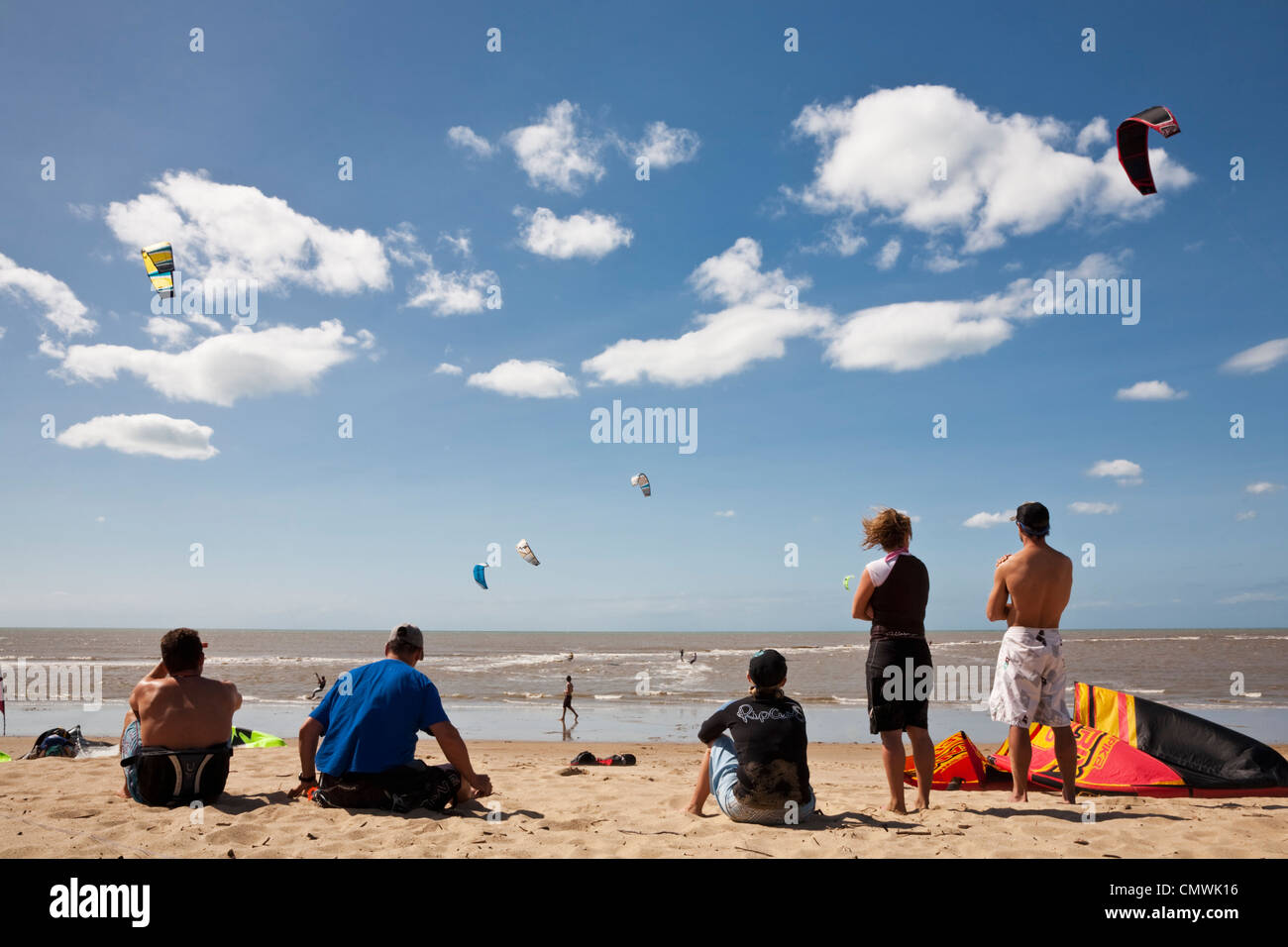 Group watching kite-surfers at Yorkeys Knob beach. Cairns, Queensland ...