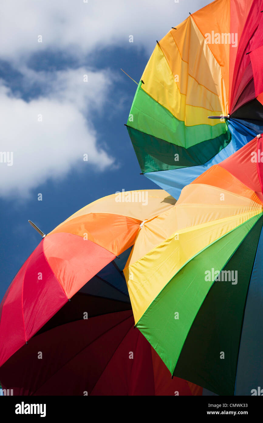 Three rainbow colored umbrellas Stock Photo - Alamy