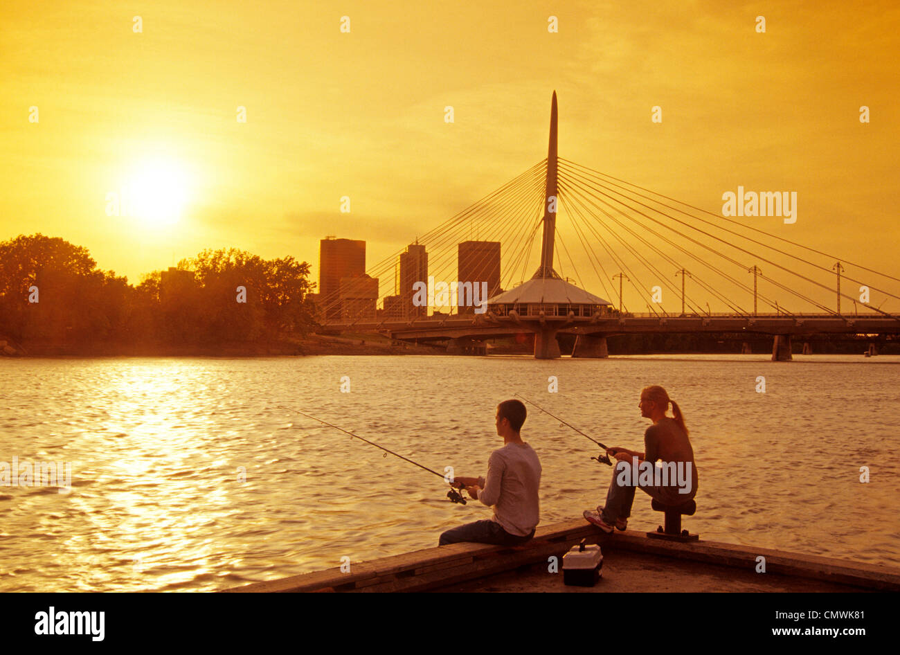 Teens Fishing from a Dock with Red River in the background, Winnipeg ...