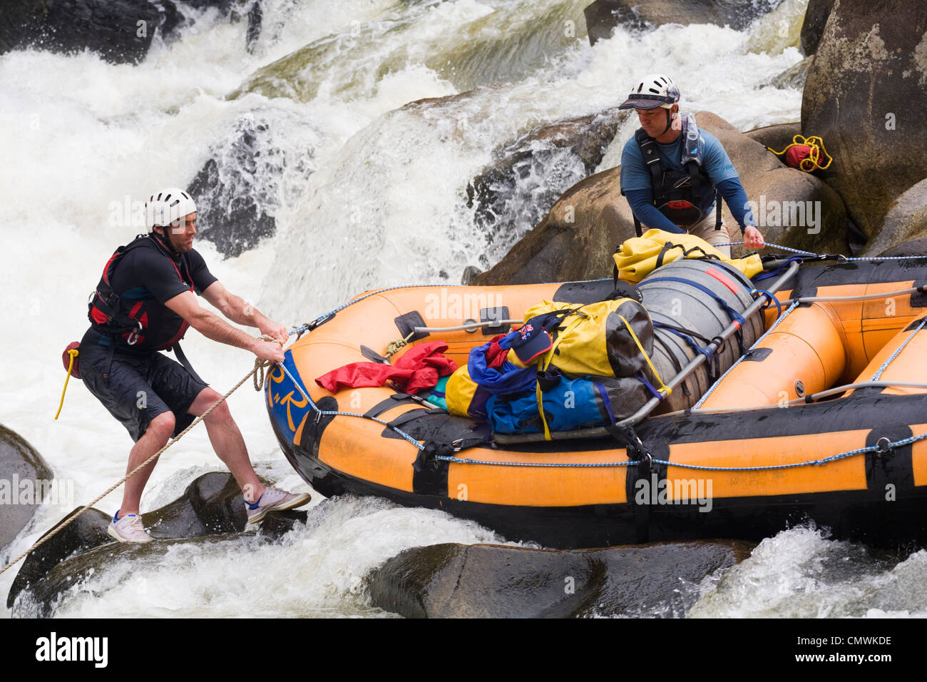 River guides drag their raft over rocks during a rafting expedition on ...