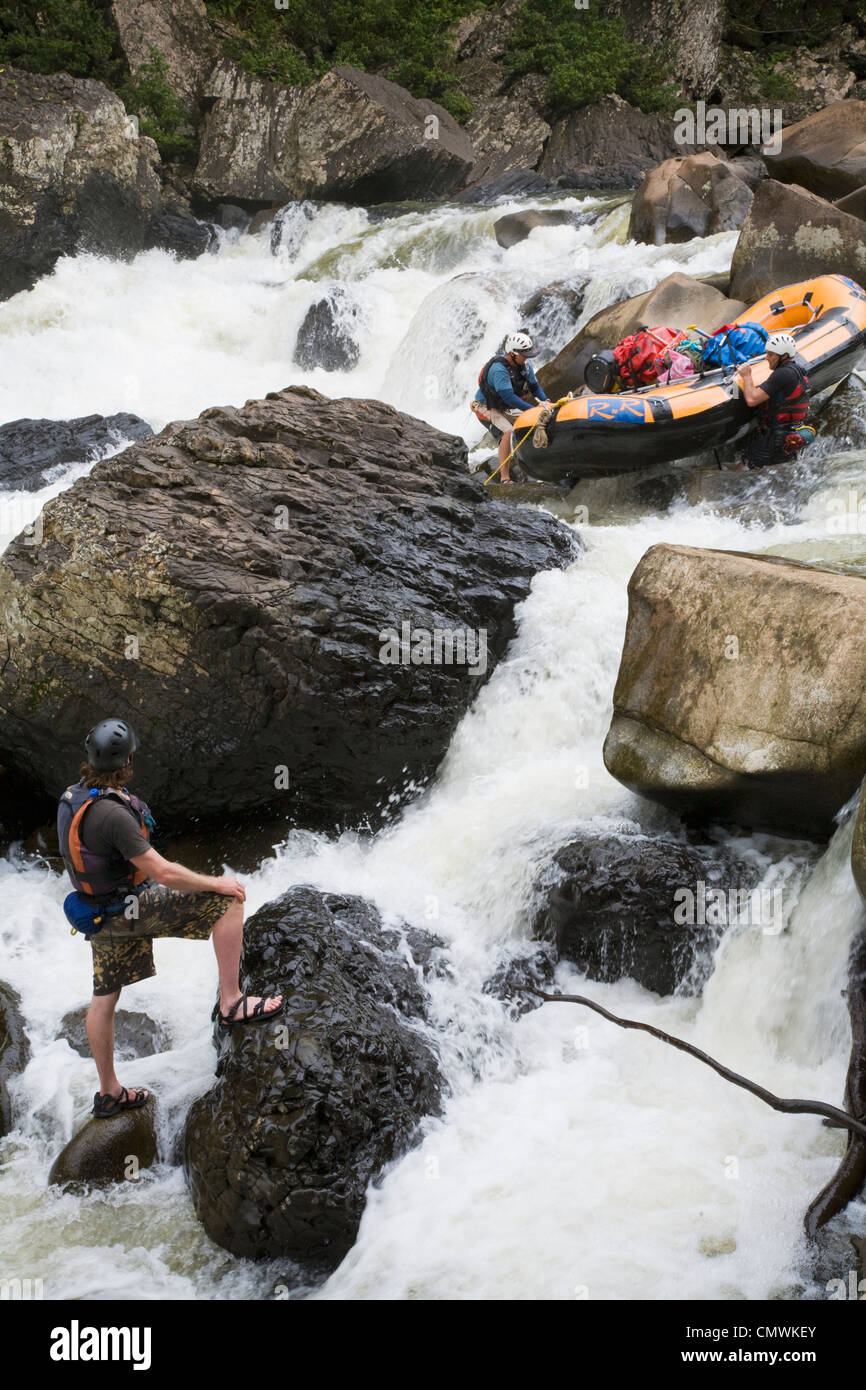 River guides drag their raft over rocks during a rafting expedition on ...