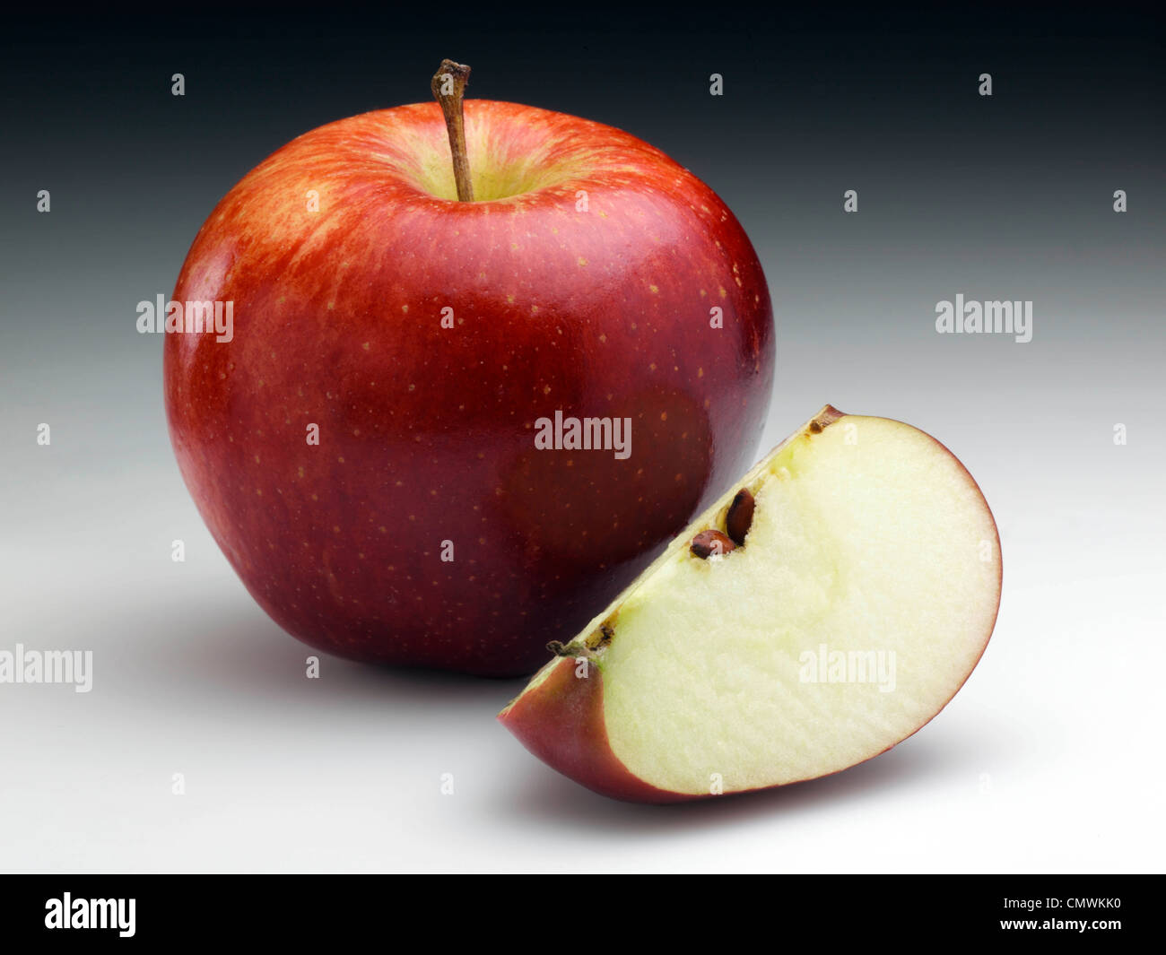 American Red Chief apple and a segment Stock Photo - Alamy